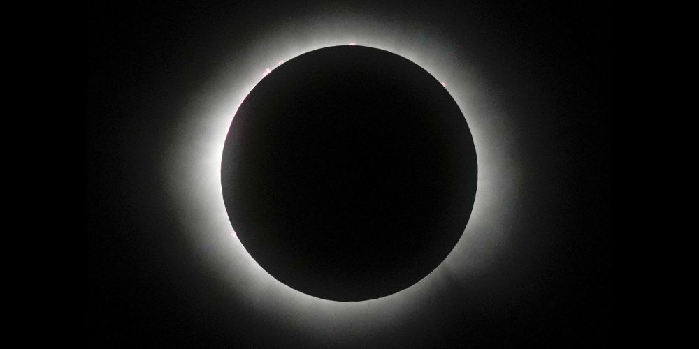 A total solar eclipse races across North America as clouds part along ...