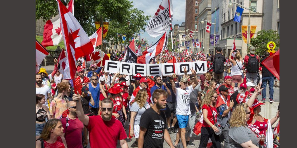 Protesters march for freedom as much larger crowds celebrate Canada Day ...