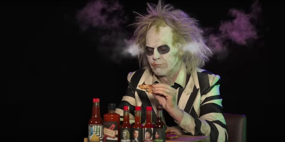 Michael Keaton interviews Beetlejuice while he snacks on hot wings in ...